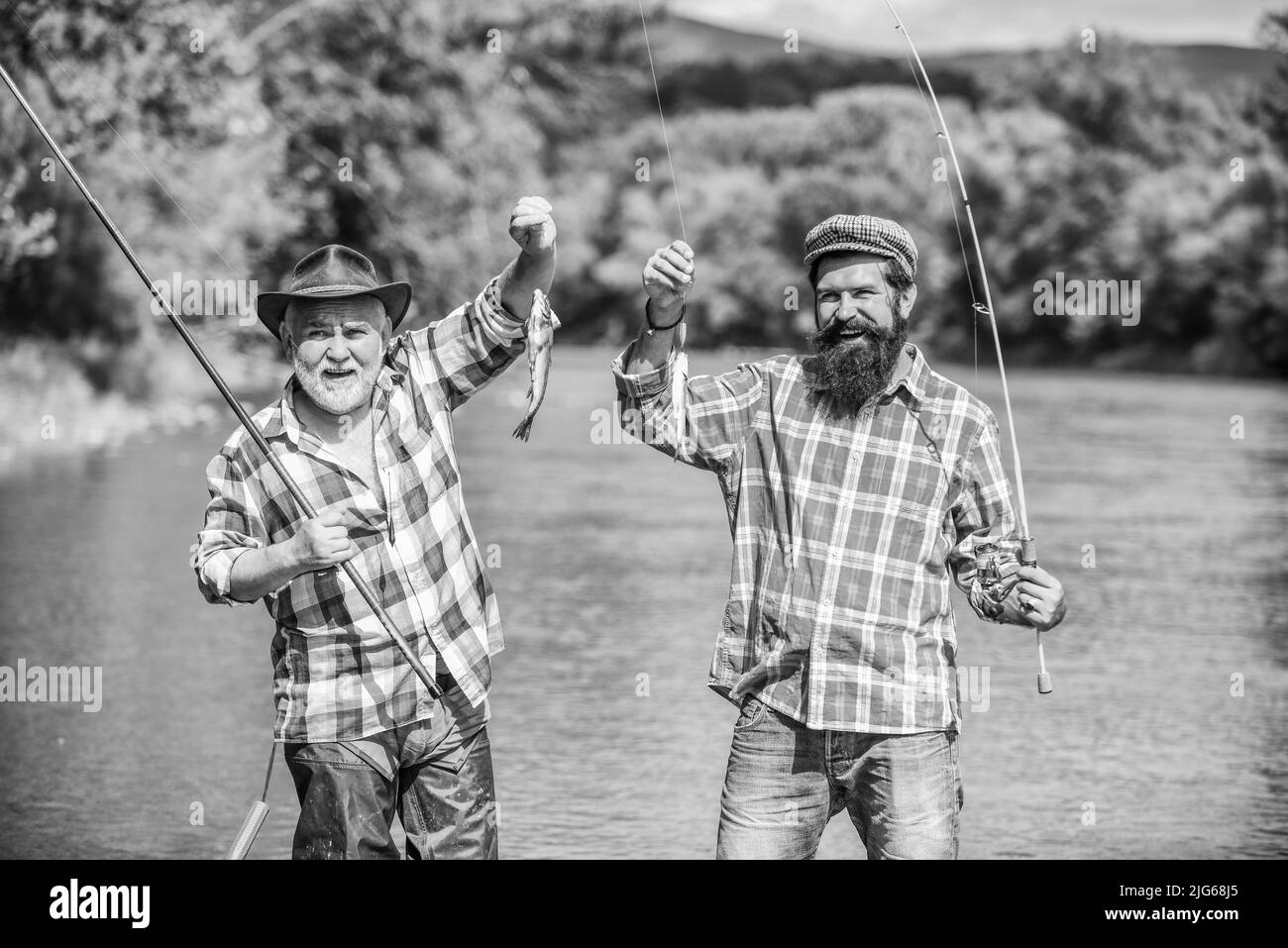 Mature man with friend fishing. Summer vacation. Happy cheerful people ...