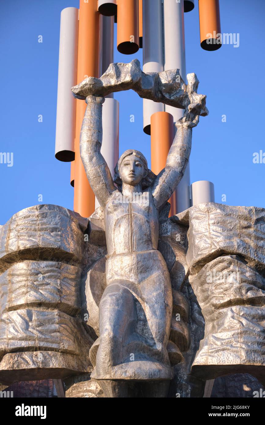 Detail of a woman proudly holding something in victory. Cloth? Flame ...