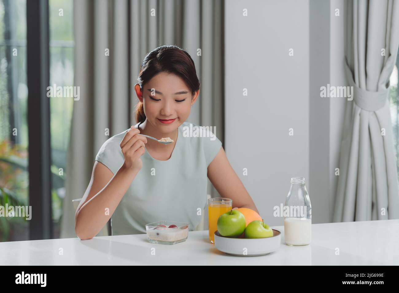 Pretty girl, happy meal eating healthy breakfast in morning Stock Photo ...