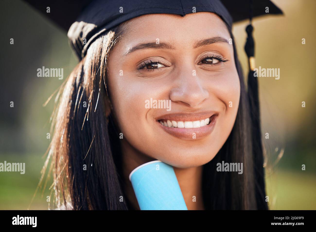 Lets see what happens next. Portrait of a young woman holding her ...