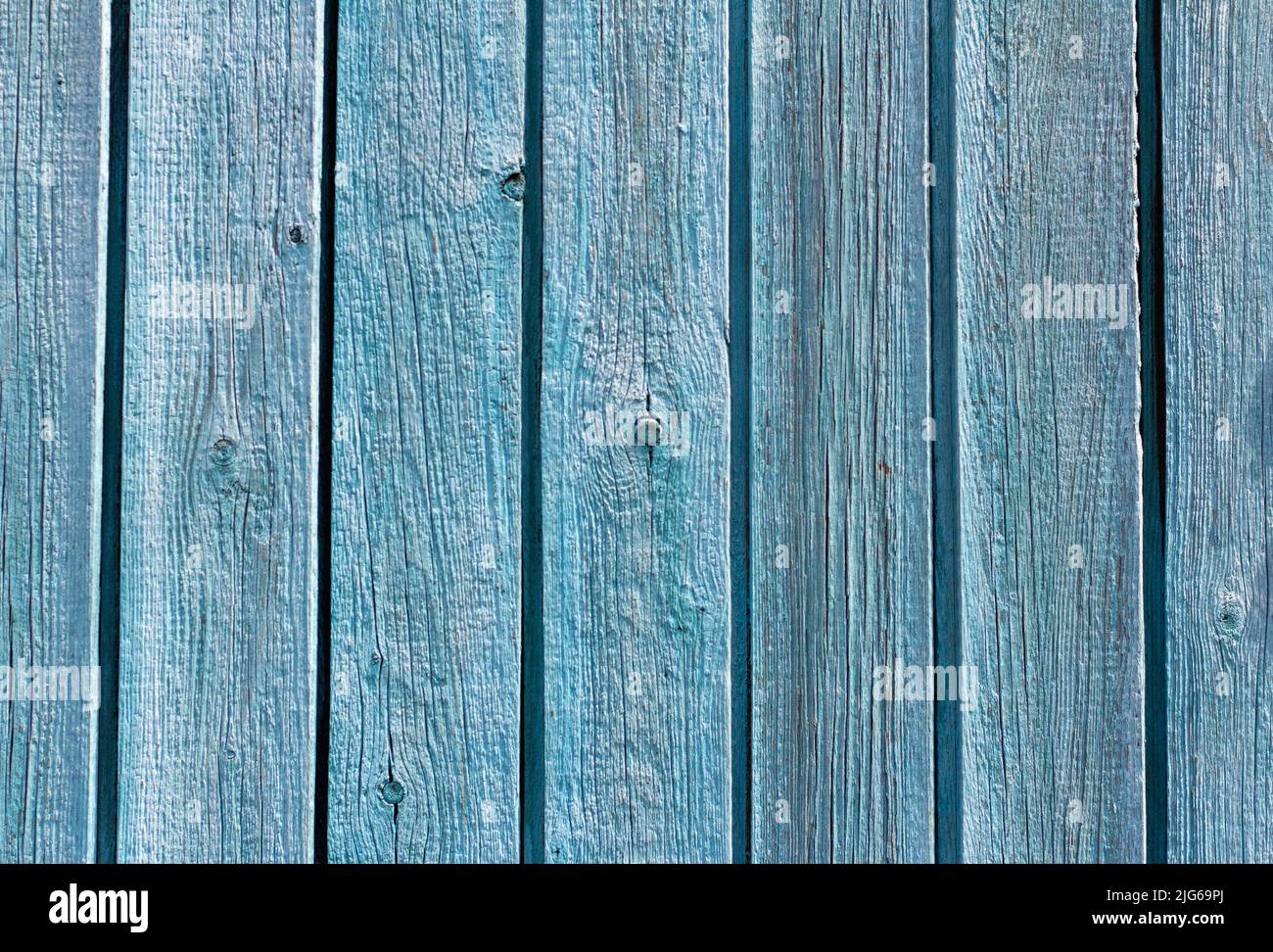 The texture of an old weathered wooden wall with blue paint. Blue ...
