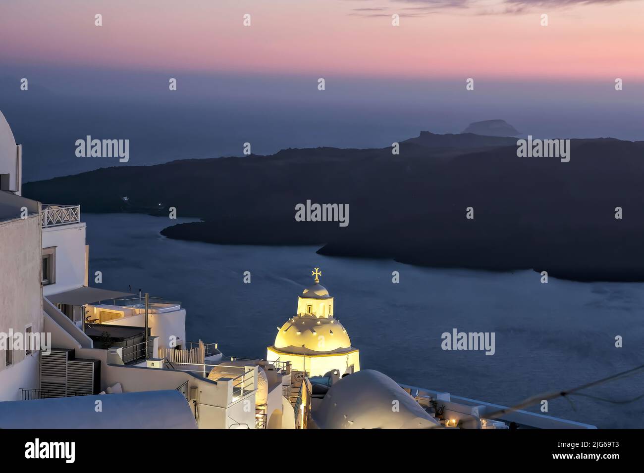 Panoramic view of the picturesque village of Fira and a stunning sunset ...