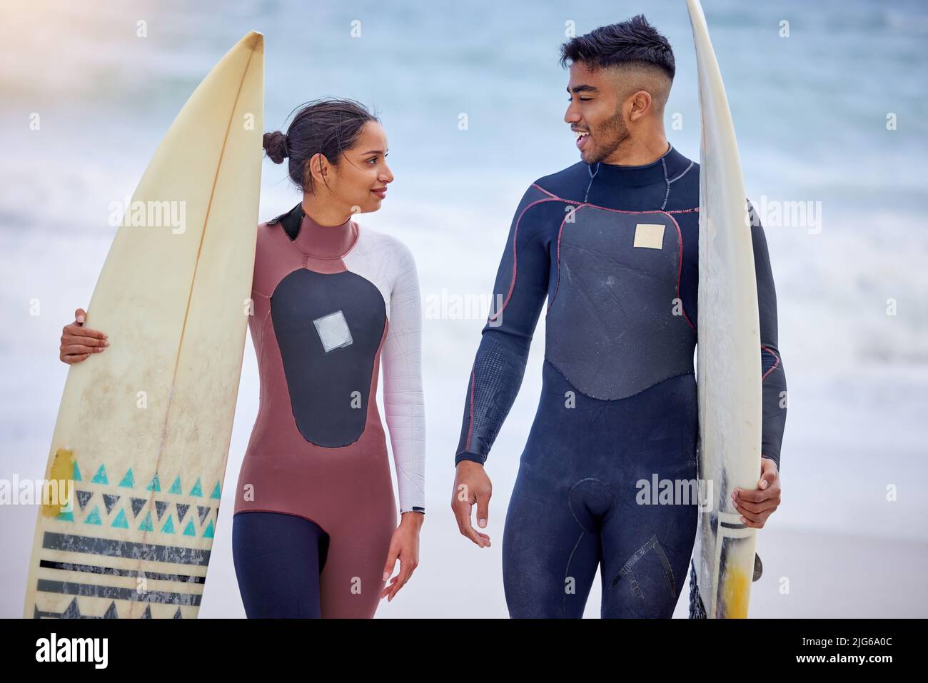 Its a fun activity for couples to enjoy. Shot of a young couple surfing ...