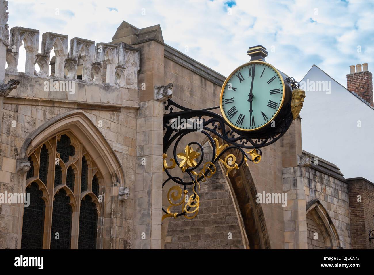 Close up modern style clock on the medieval stone walls of York ...