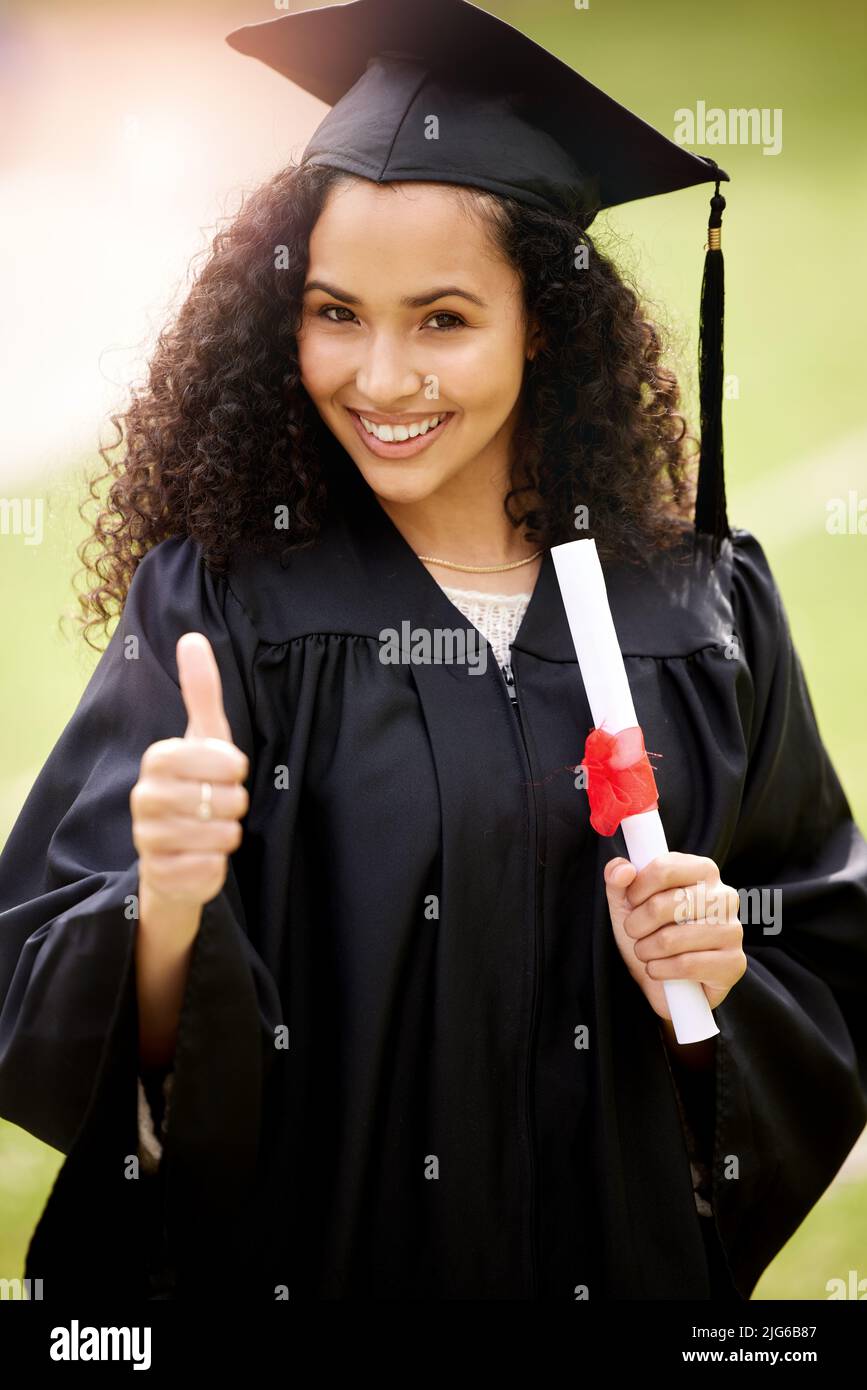 A job well done indeed. Portrait of a young woman showing thumbs up on ...