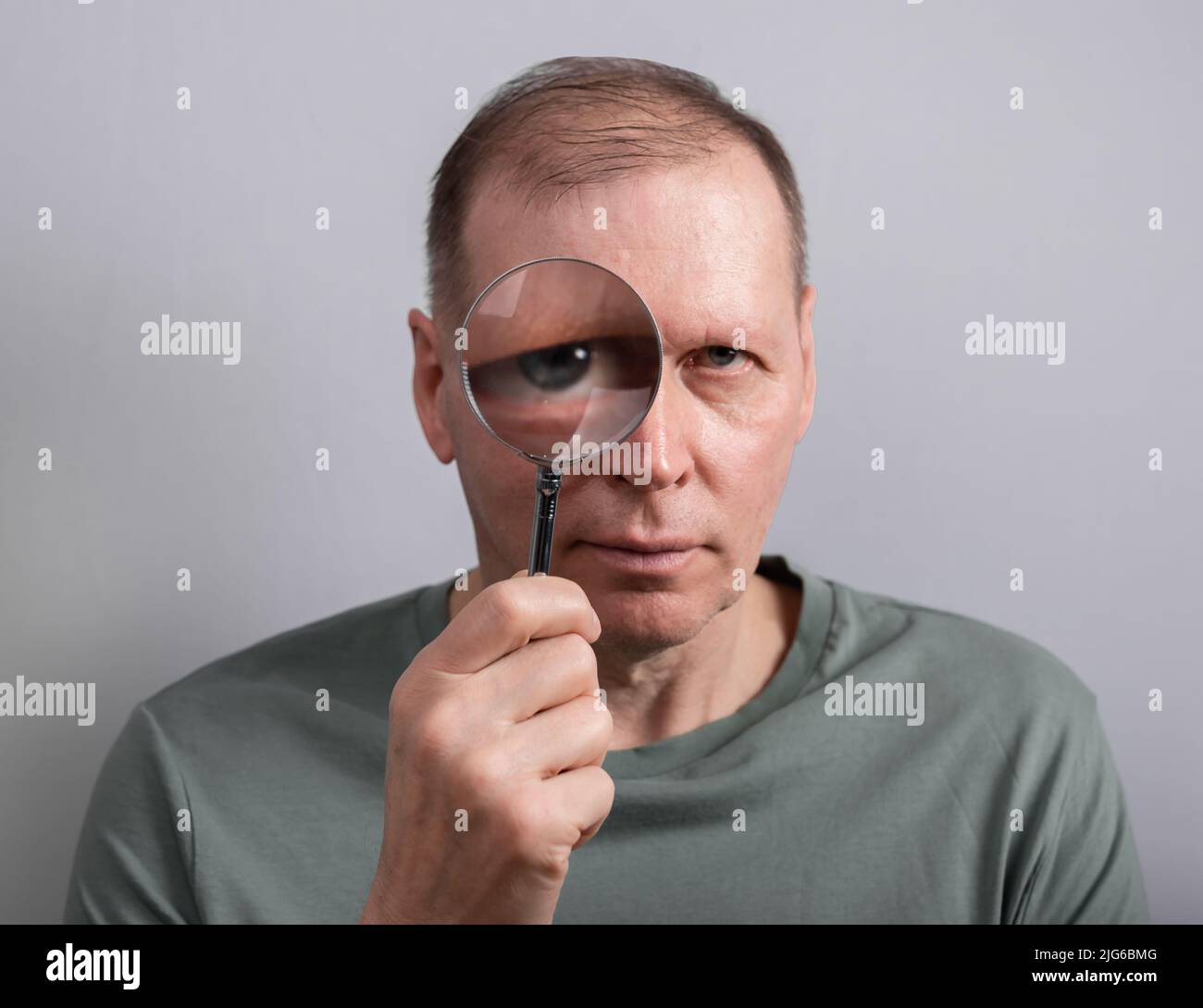 Man looking through magnifying lens glass portrait. High quality photo ...