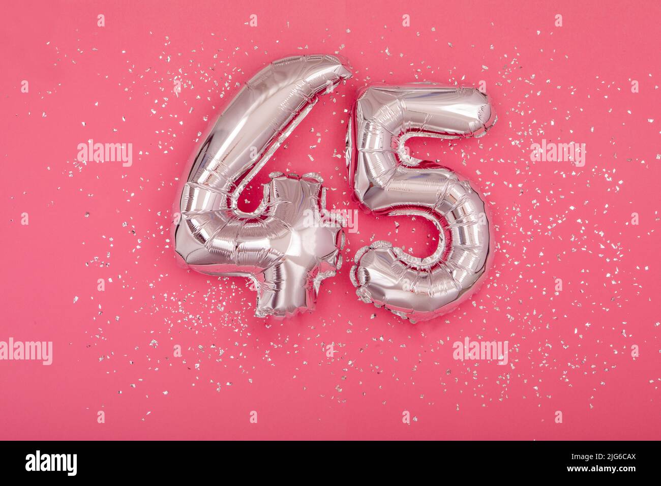 Silver balloon shape of number fourty five 45 pink background Stock ...