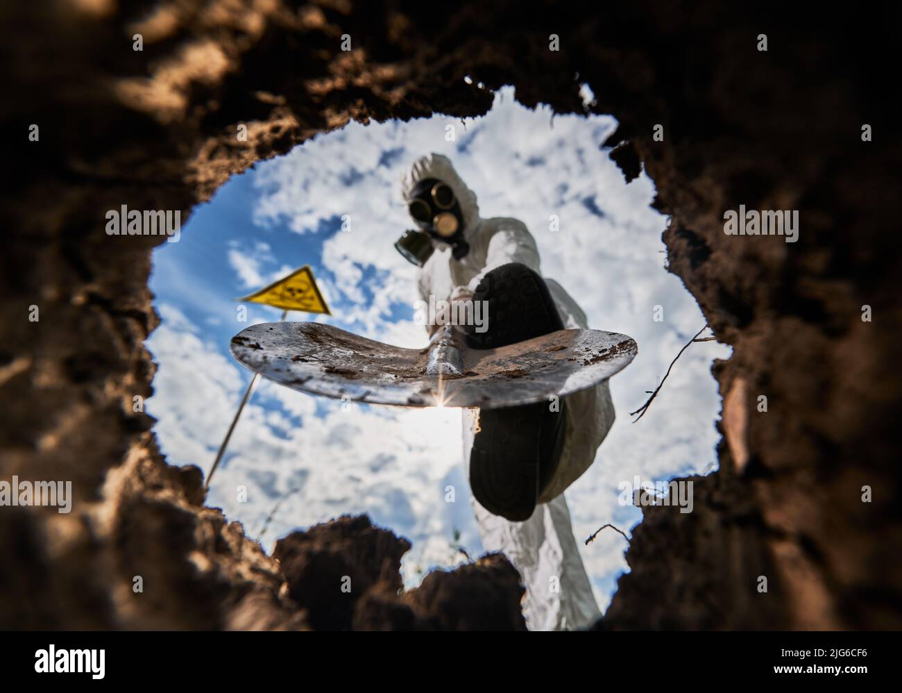 Close up view from inside pit of shovel digging by person in protective ...