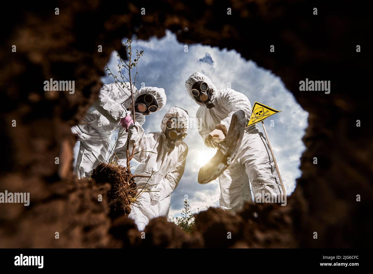 Concept of post apocalypse - people in white overalls and gas masks ...