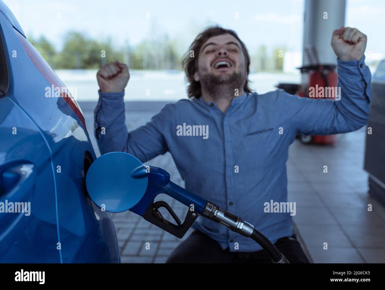 refueling a car with gasoline at a gas station. Rise in fuel prices ...