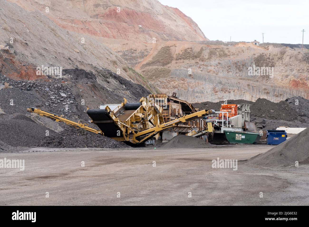 Machinery for moving and loading recycled asphalt concrete at an ...