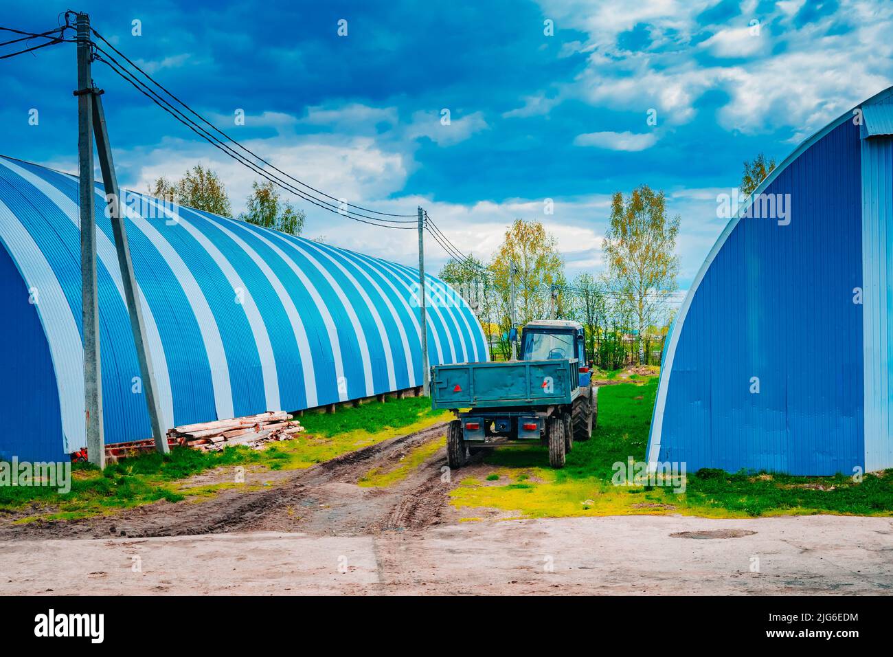 Blue tractor with trailer. Equipment for agriculture. Successful ...