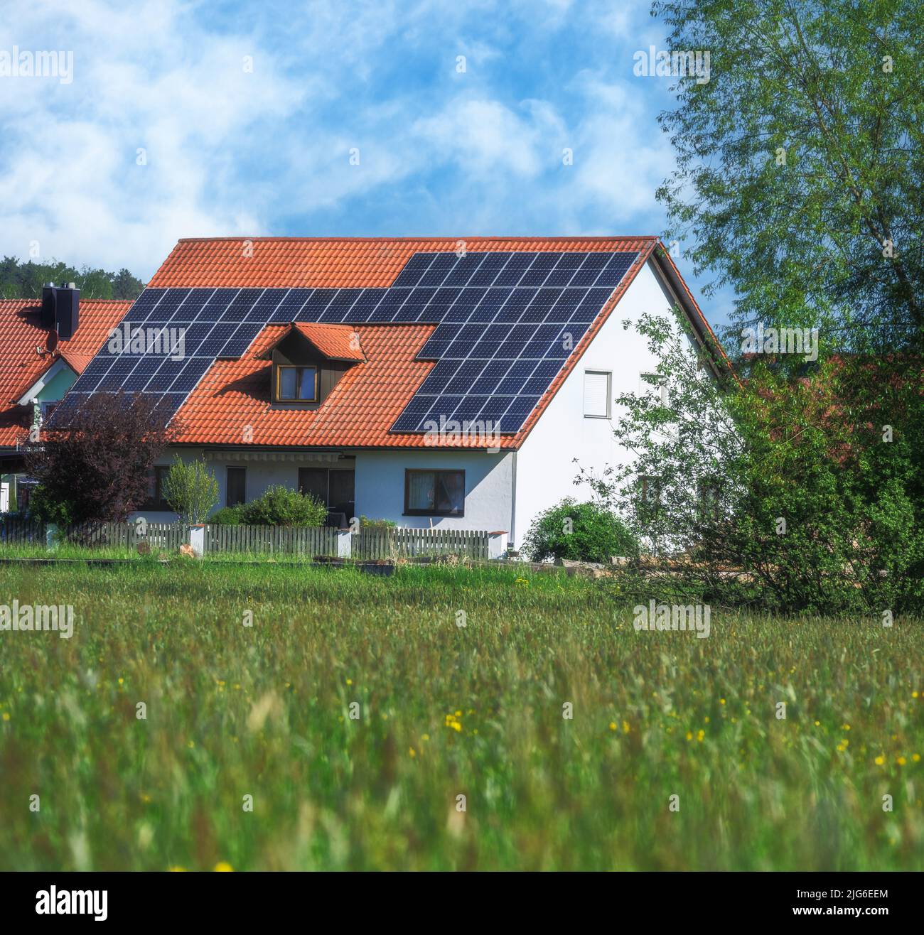 Modern house with photovoltaic solar cells on the roof for alternative ...