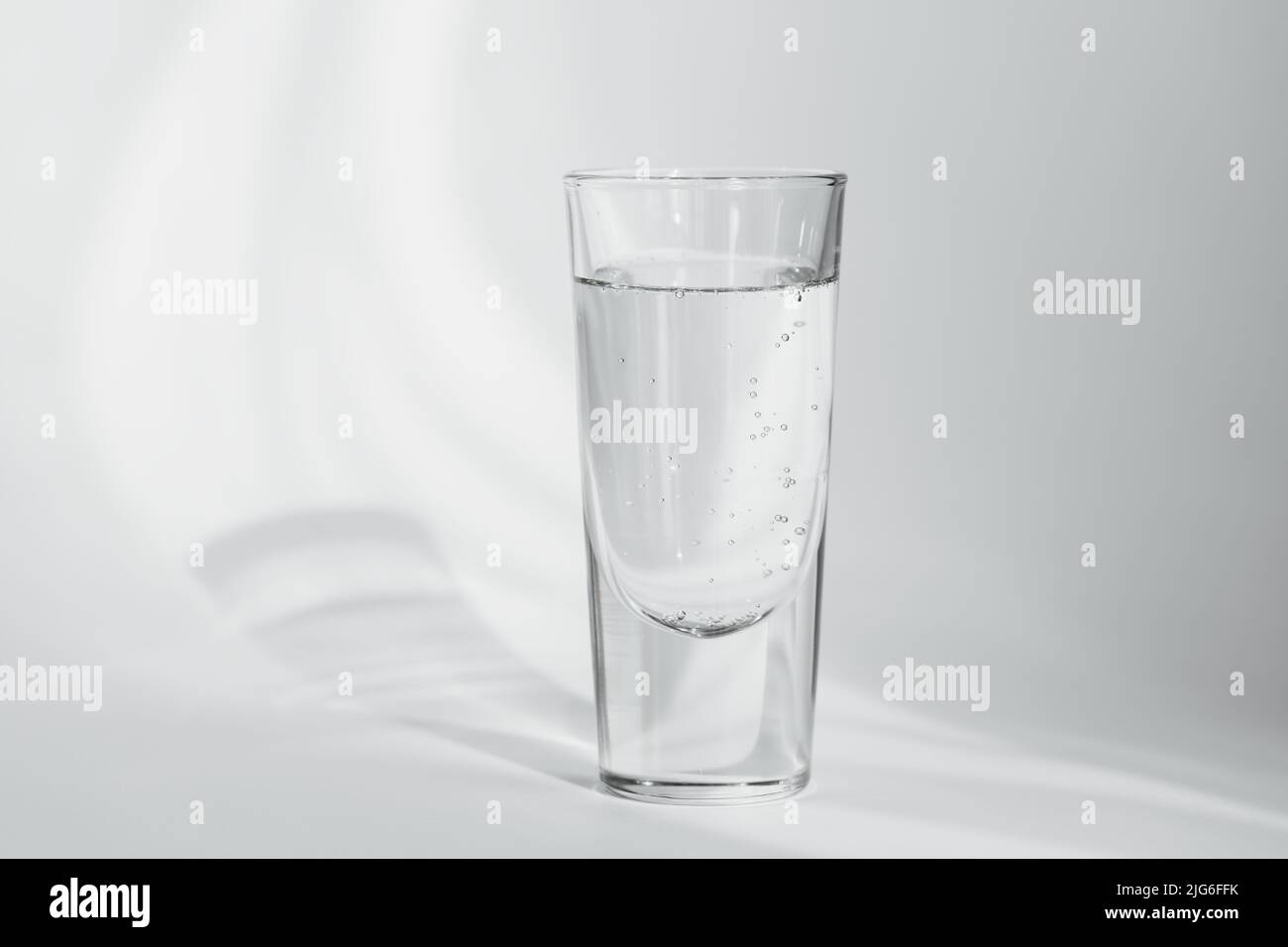 Glass of clean mineral sparkling water on white background Stock Photo - Alamy