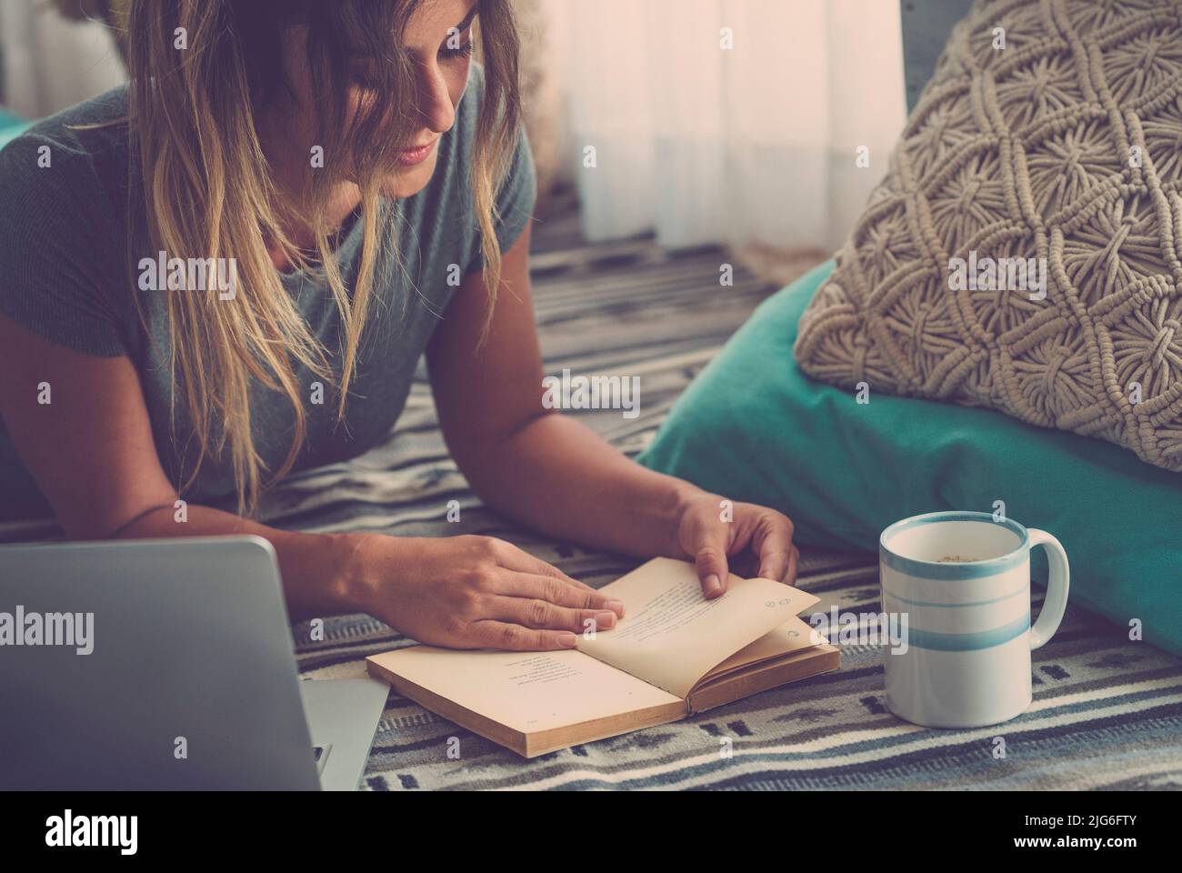 Home indoor leisure activity people. Young happy alone woman reading a ...