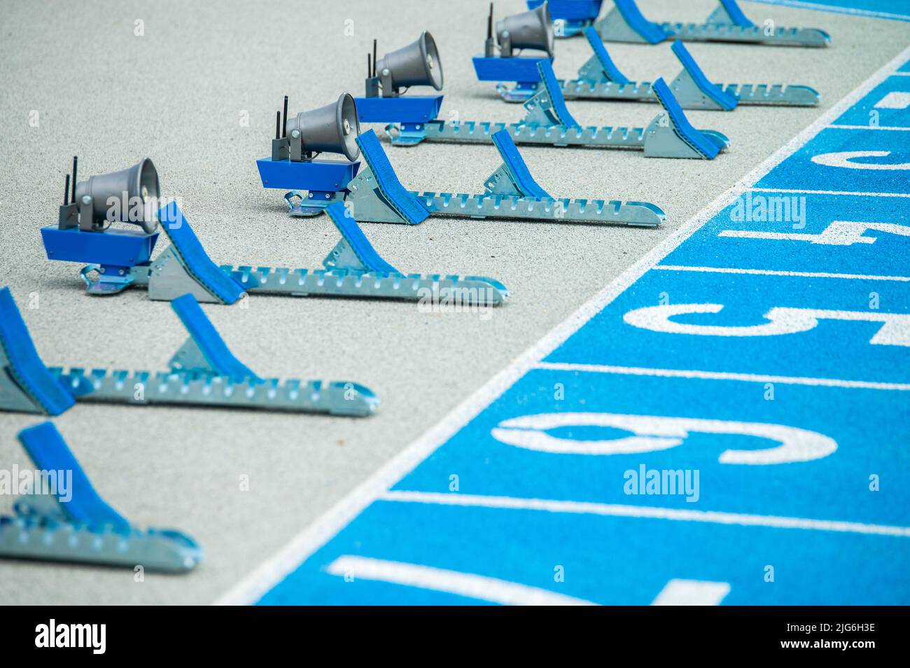 Running background. Start line, athletics track and starting blocks ...