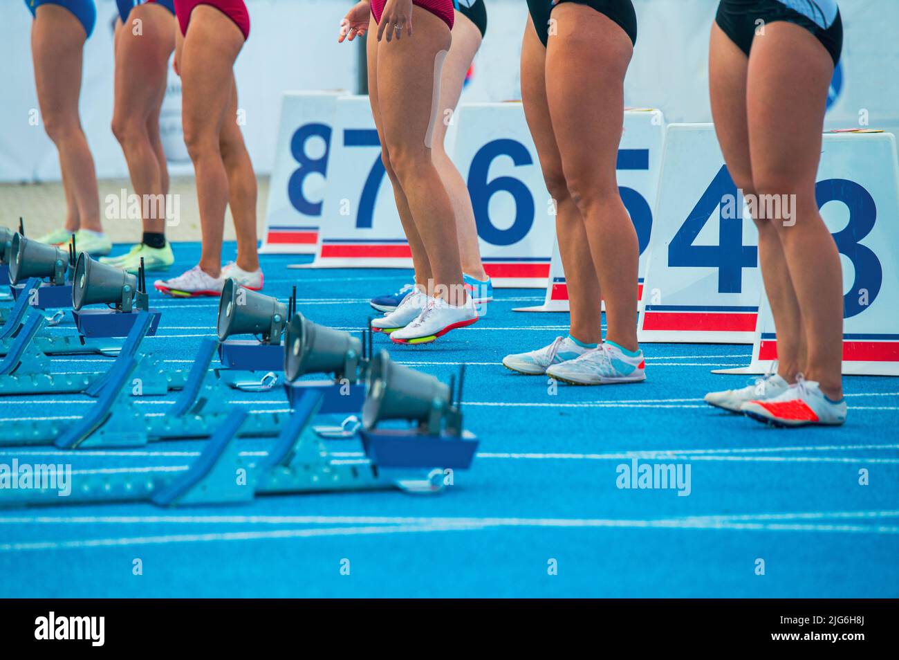 Track and field, running and sprinting. Legs of professional athletes ...
