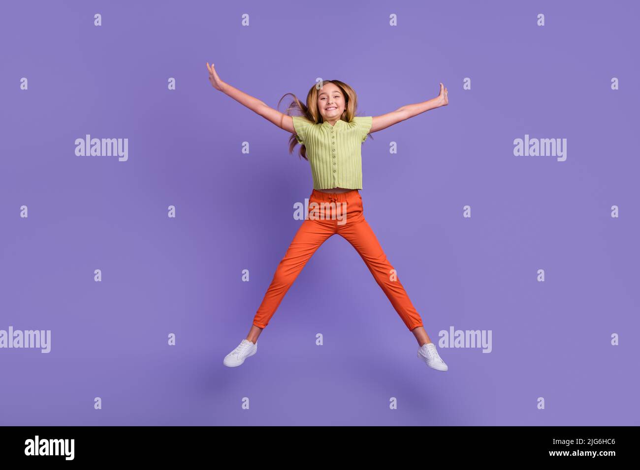 Full body portrait of overjoyed energetic girl jumping make star figure ...