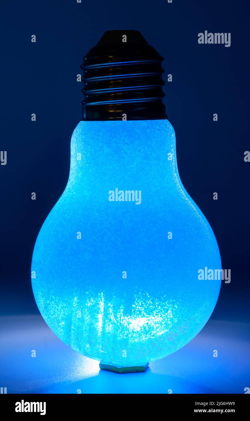 Blue Liquid inside light bulb on dark background with the backlight ...