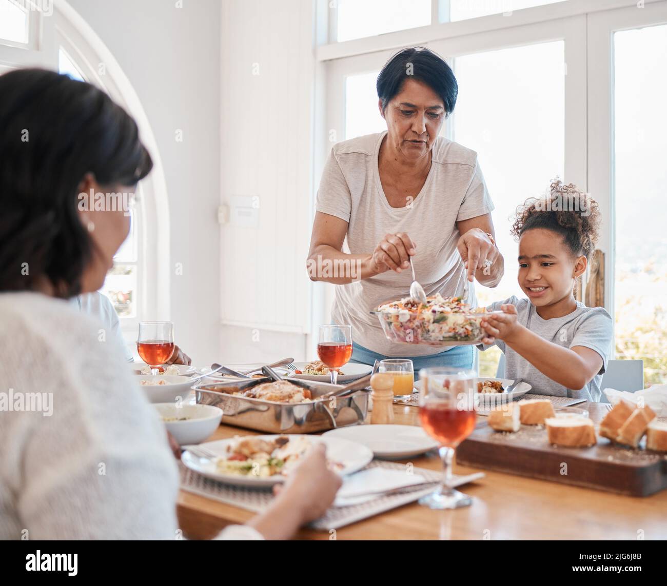Be thankful for this food. Shot of a grandmother serving food to her ...