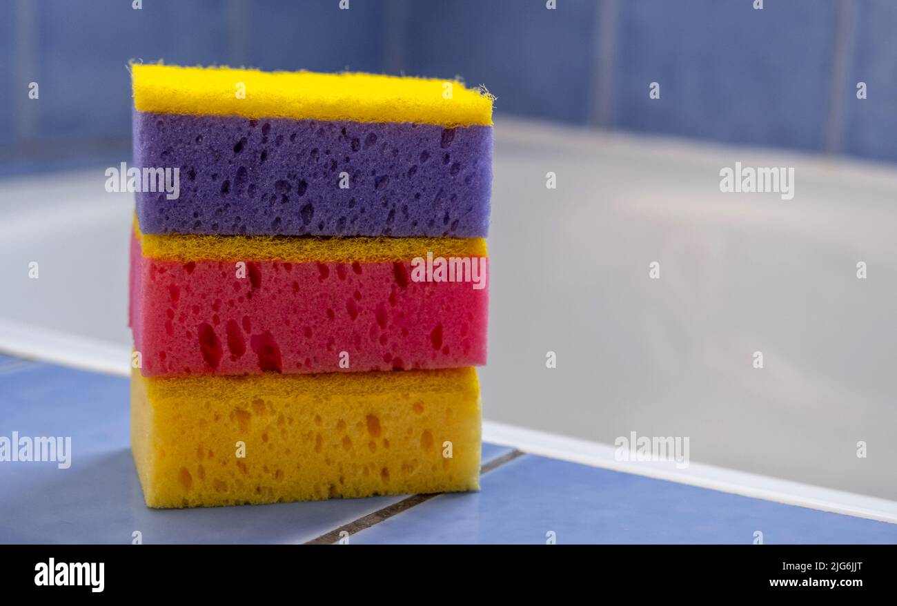 Sponges inside bathroom. Closeup. Set of colorful accessory for house ...