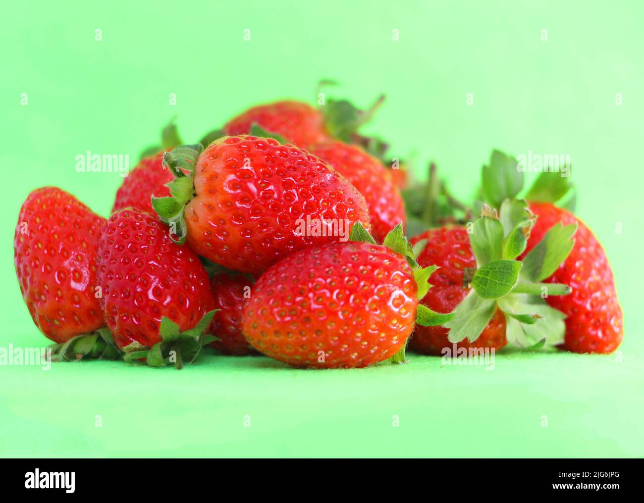 Sweet Small Strawberry fruits on the green sheet background wallpaper ...