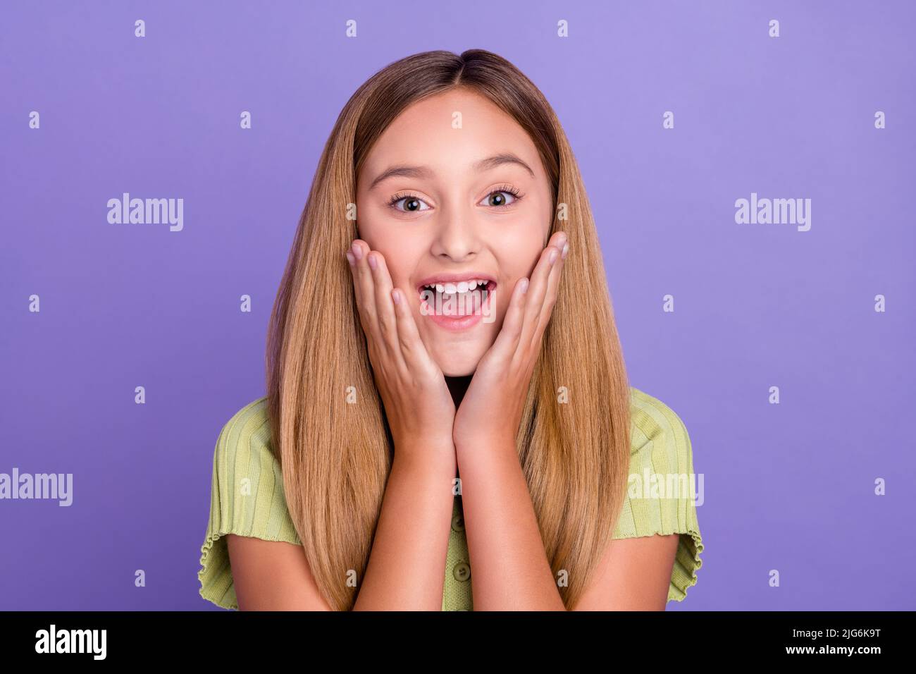 Portrait of astonished positive girl arms touch cheekbones open mouth ...