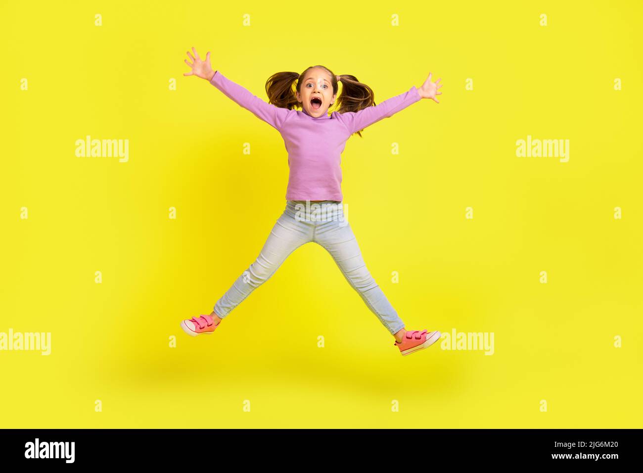 Full size photo of excited school child jump high moving scream ...
