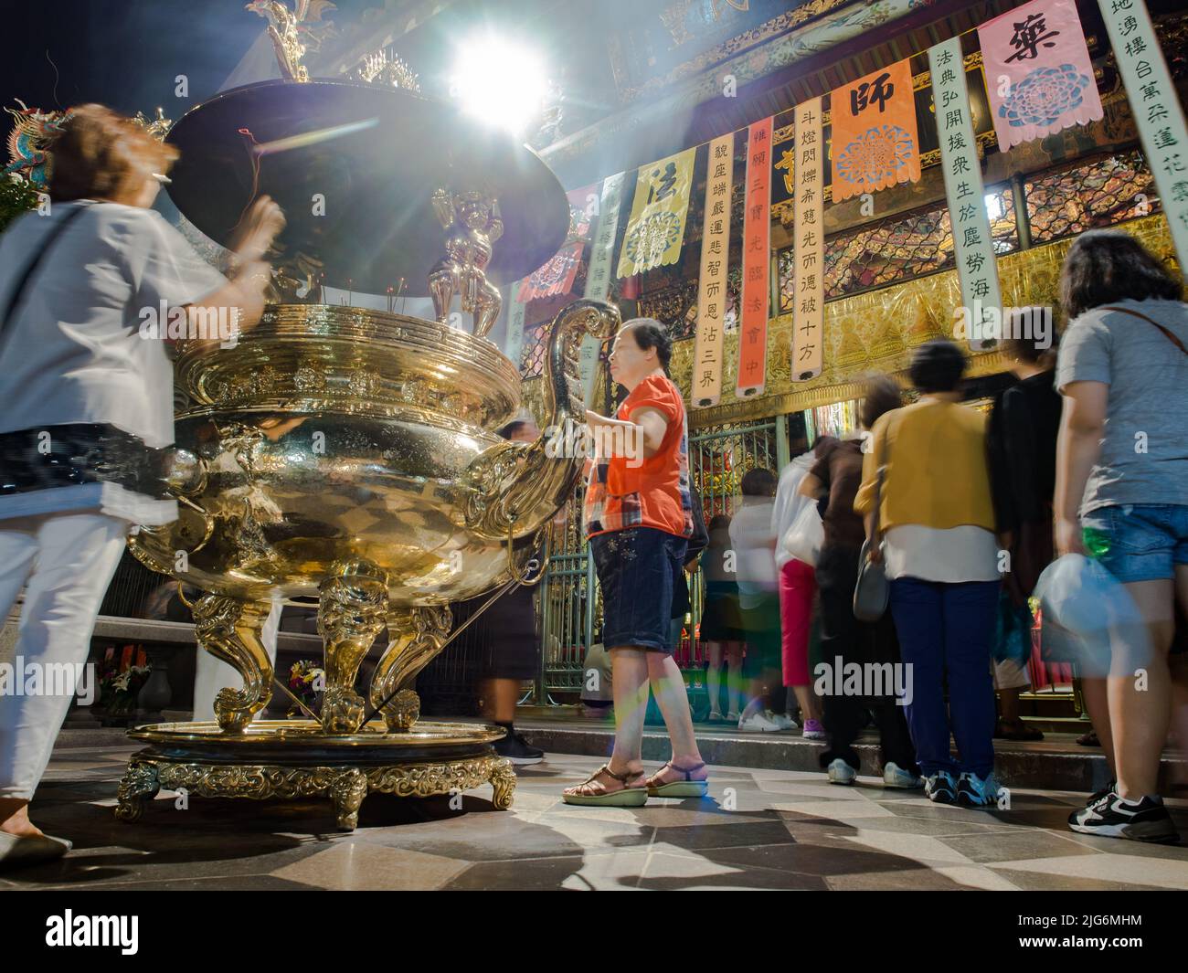 Taipei, Taiwan - October 2016: Golden censer and praying people in a ...