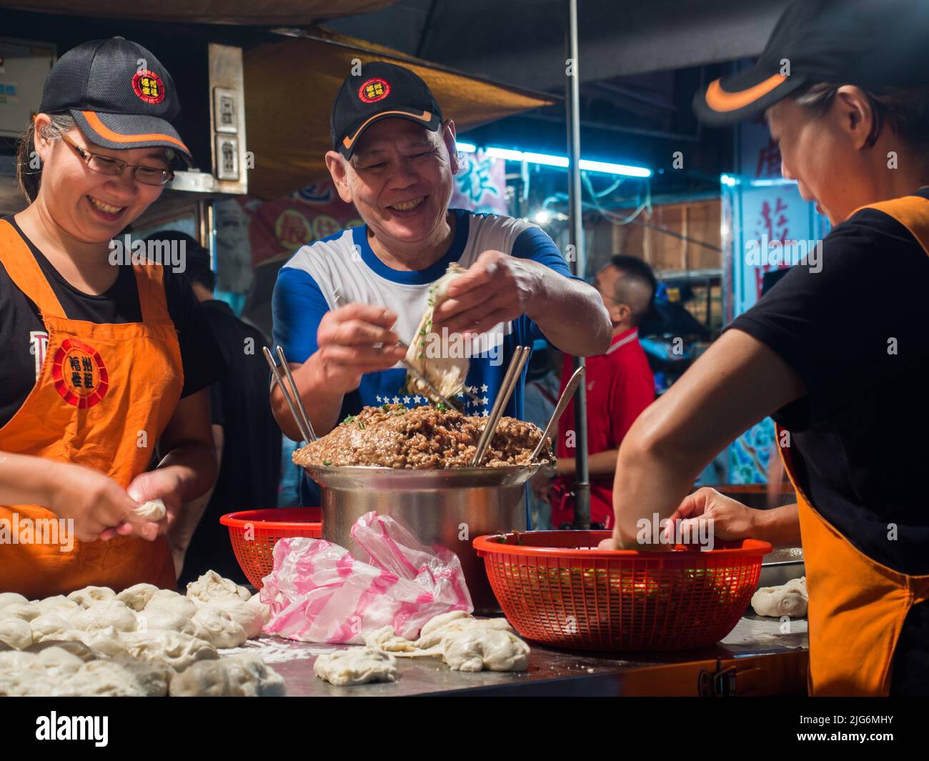 Taipei, Taiwan - October 2016: A group of happy Taiwanese prepare food ...