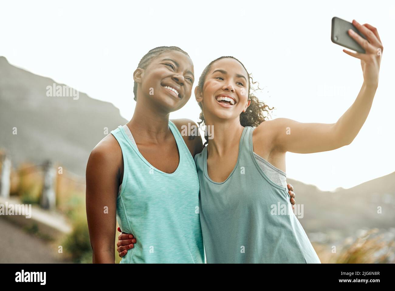 Building our dream bodies together. Shot of two friends taking selfies ...