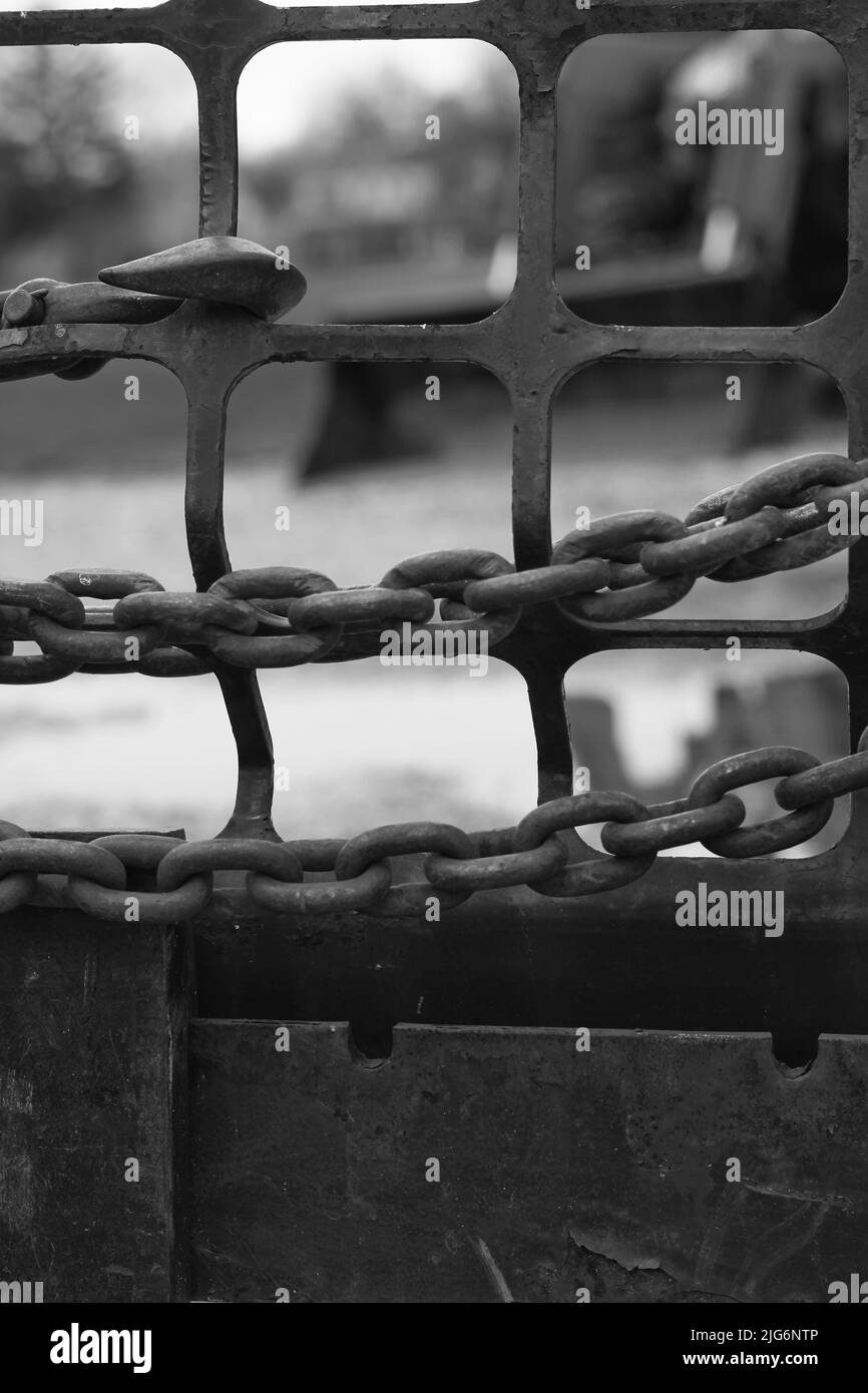 A typical rusty chain hanging a fence Stock Photo - Alamy