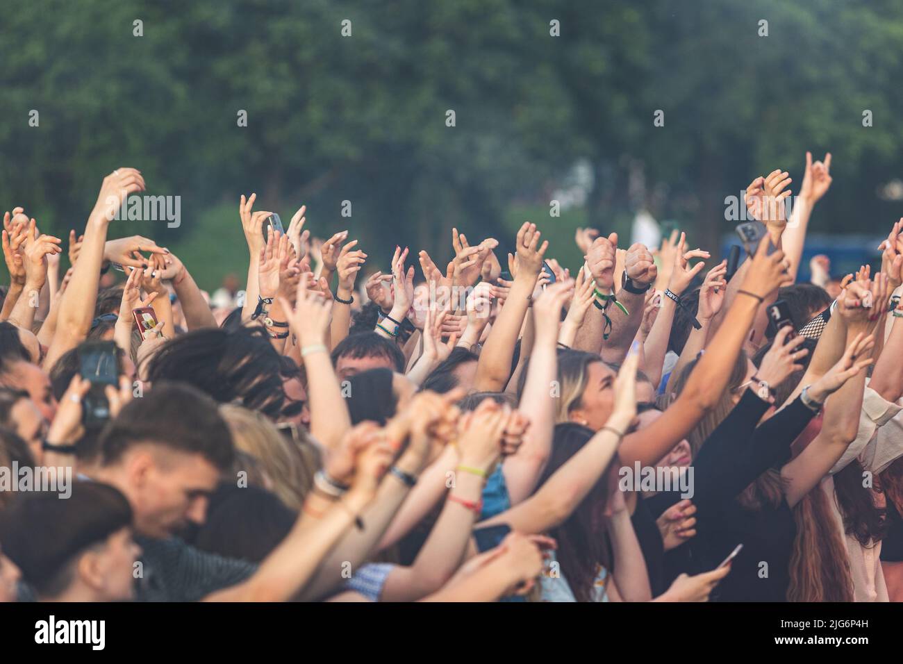 Young people raised hands in the air at the music festival Stock Photo ...