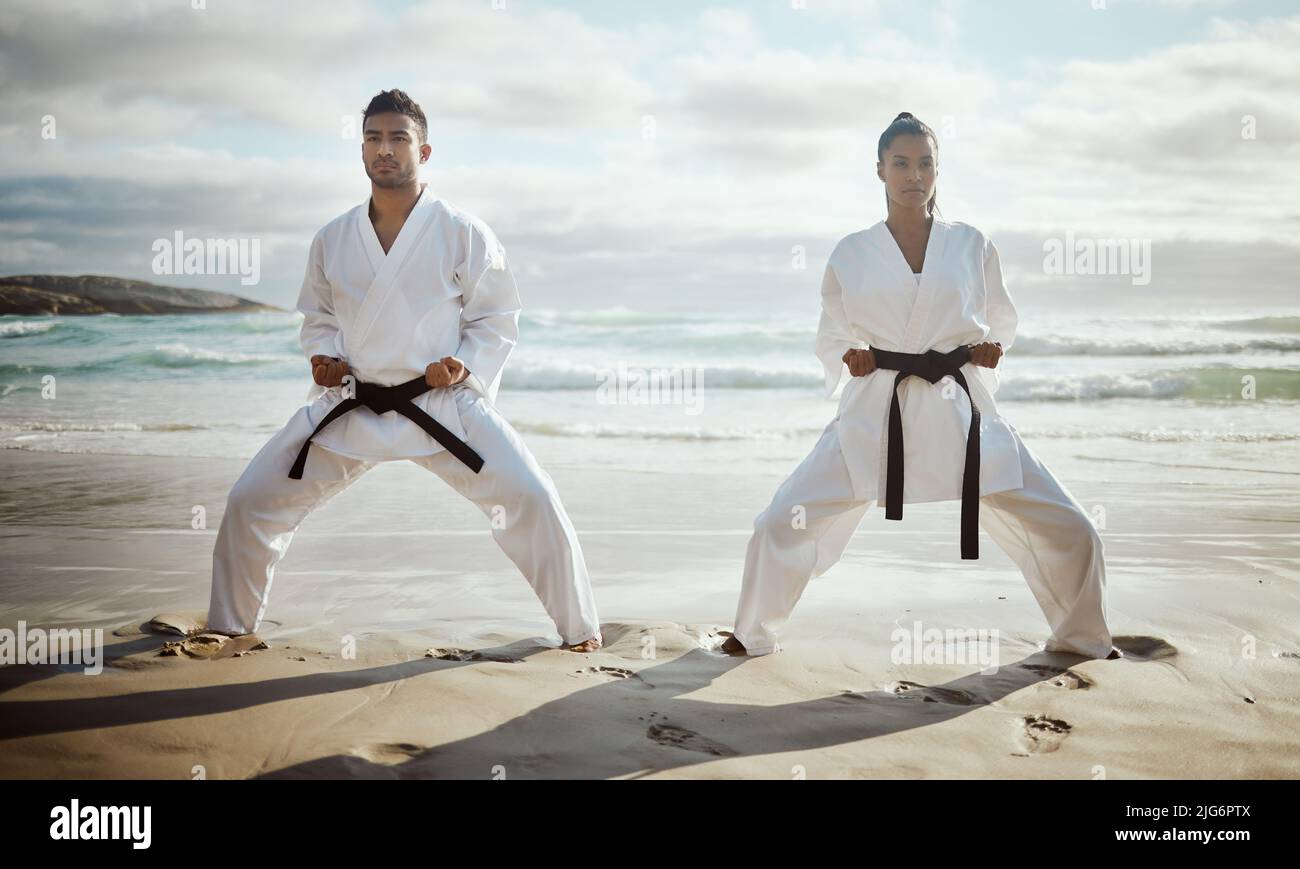 Ready for a fight. Full length shot of two young martial artists ...