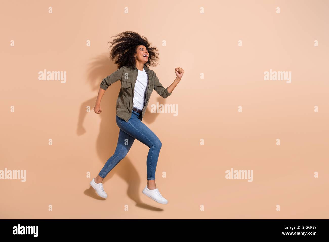 Full length body size view of pretty cheerful girl jumping running ...