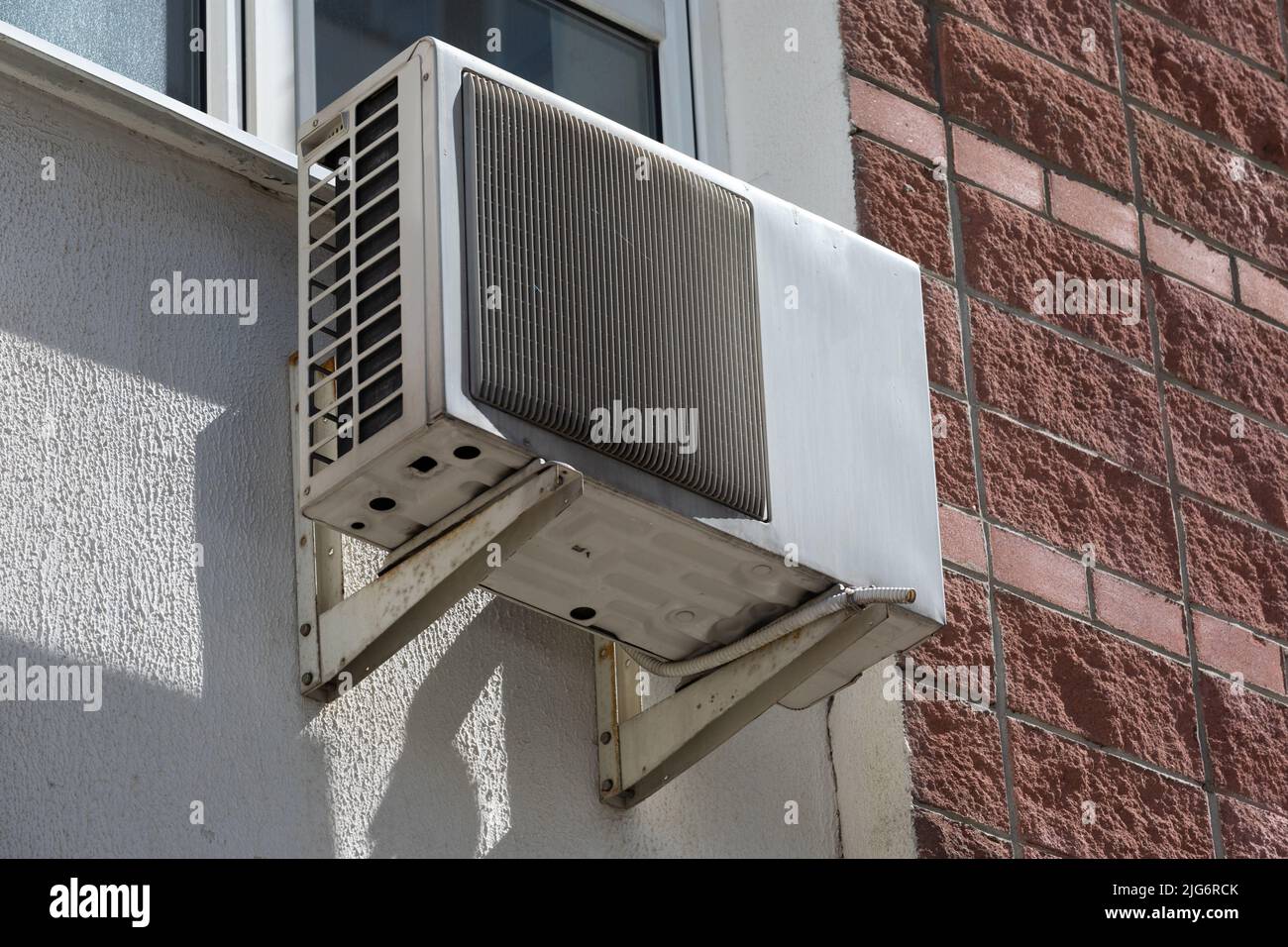 old outdoor air conditioner unit hanging outside the building Stock ...