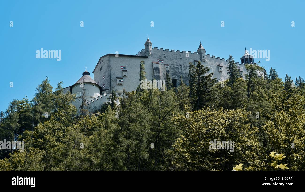 Medieval defensive castle Hohenwerfen on a hill above a forest in ...
