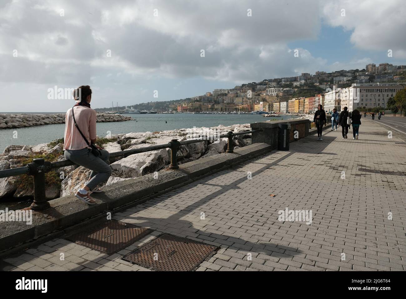 Naples, Italy - November 2, 2021. People relaxing on the Via Caracciolo ...