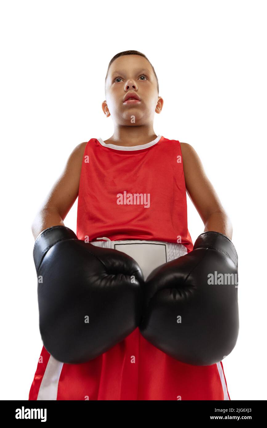 Portrait of kid, young boxer in boxing gloves and red unifprm posing ...