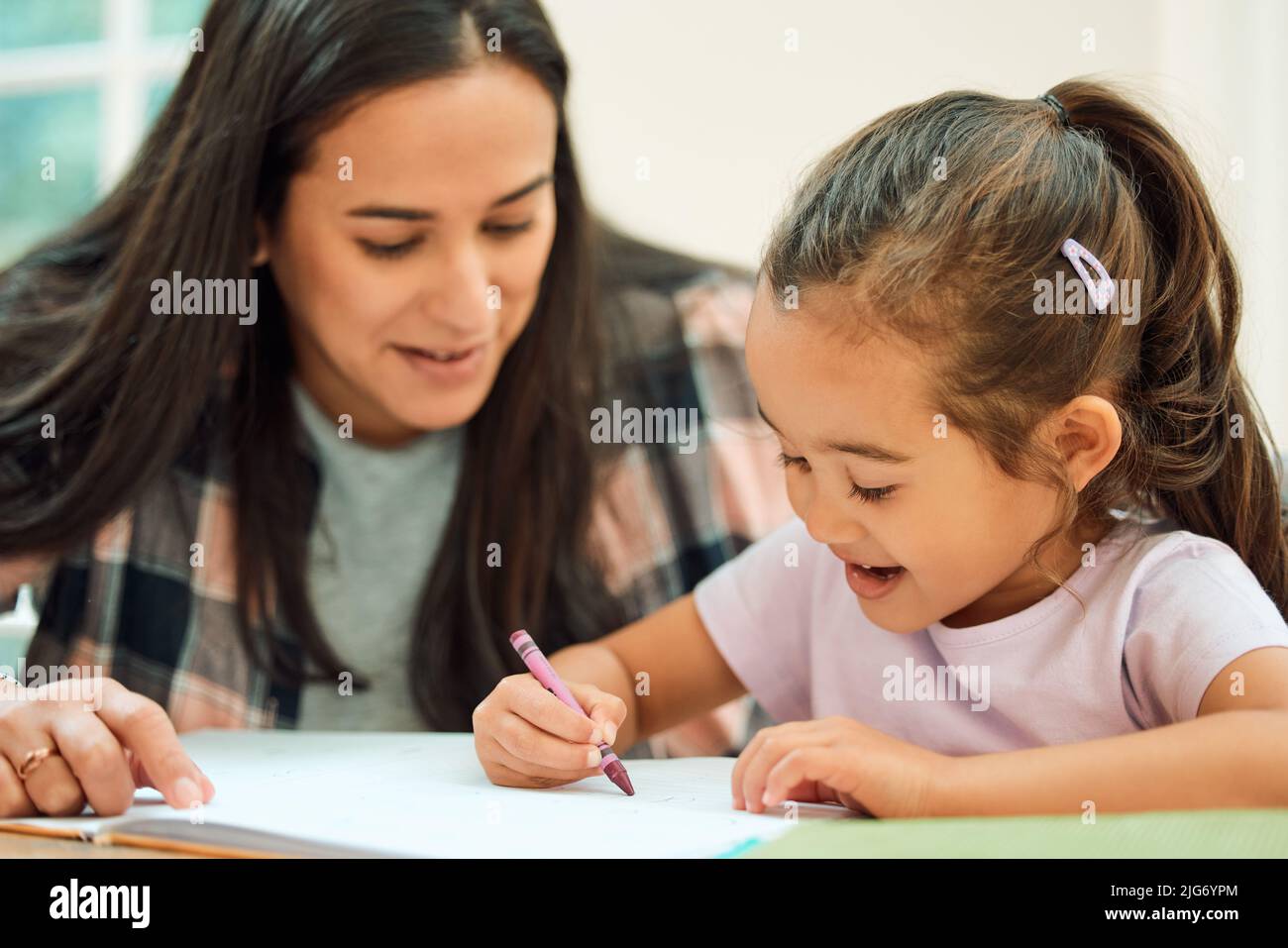 Let mommy help you. Cropped shot of an adorable little girl doing her ...