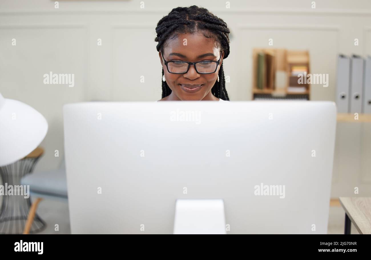 Getting things done today. Shot of a young businesswoman using a ...