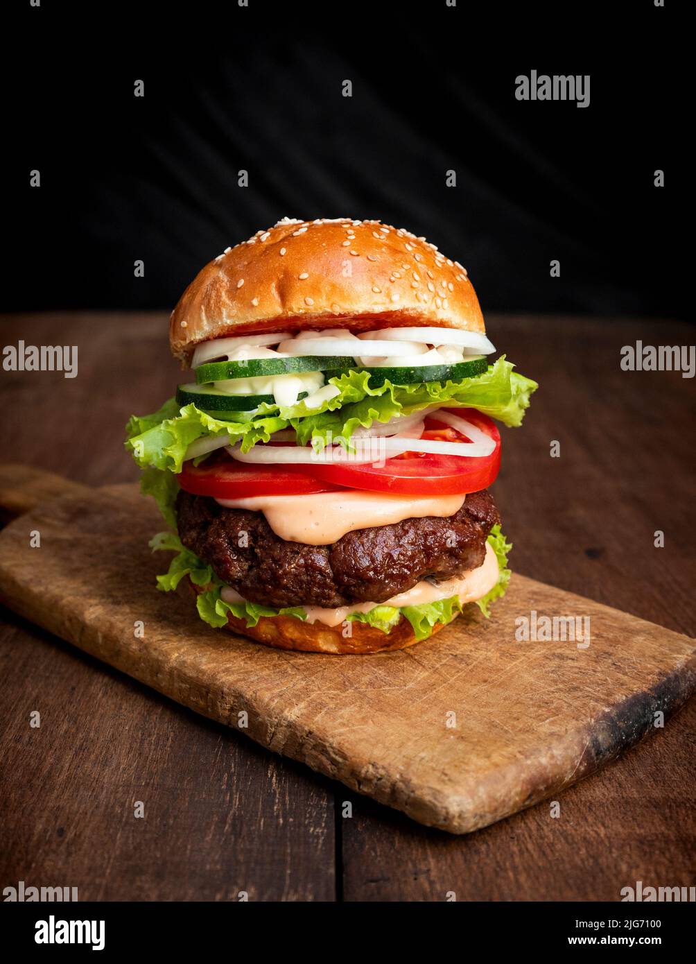 Burger with beef meat, cheese, lettuce, onion, tomato, cucumber, mayo ...