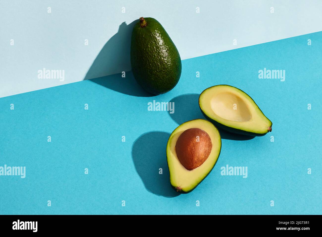 Composition of fresh fruits, whole avocado and two halfs of cutted ...
