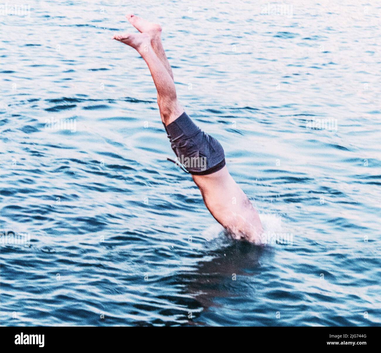 guy dives into the water (soft focus Stock Photo - Alamy