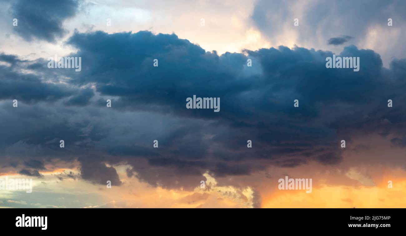 Cumulus cloudscape white grey color and orange shade. Sunset light ...