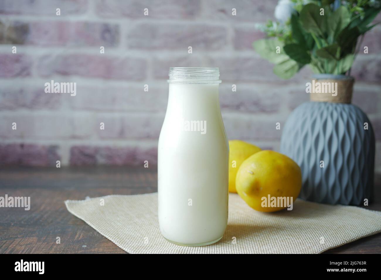 bottle of milk and a lime on table Stock Photo - Alamy