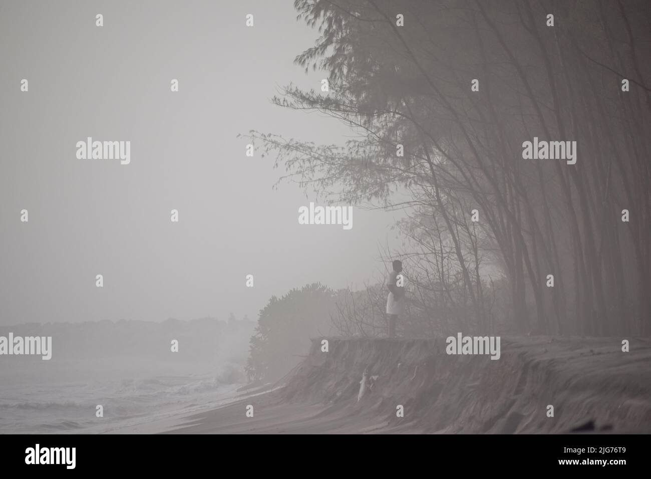 Foggy Indian beach and a man Stock Photo - Alamy