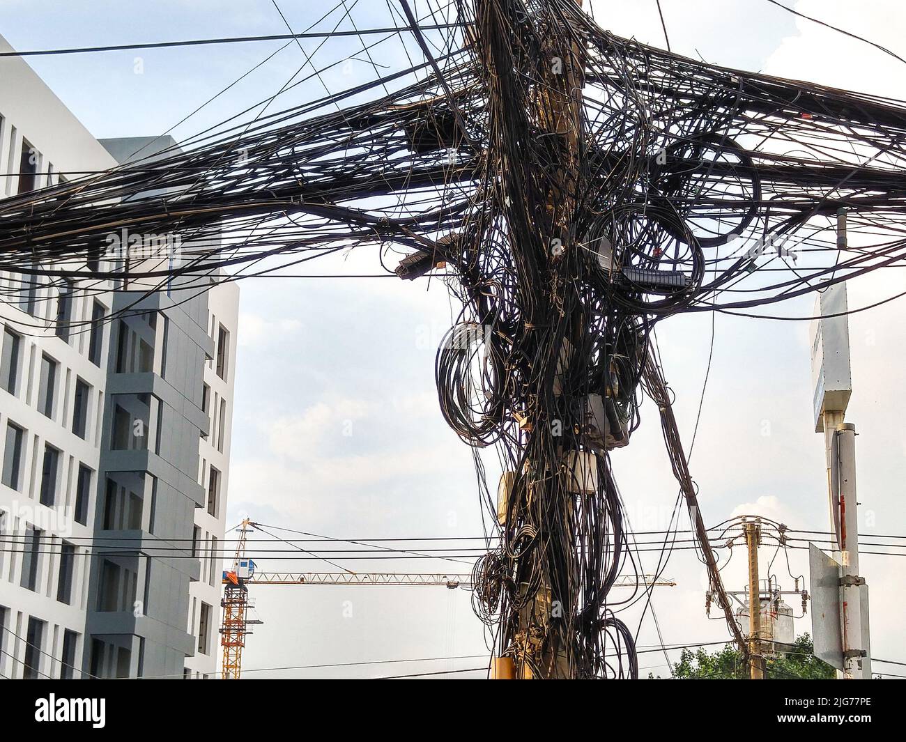 An electric pole supports a series of entangled electrical systems ...