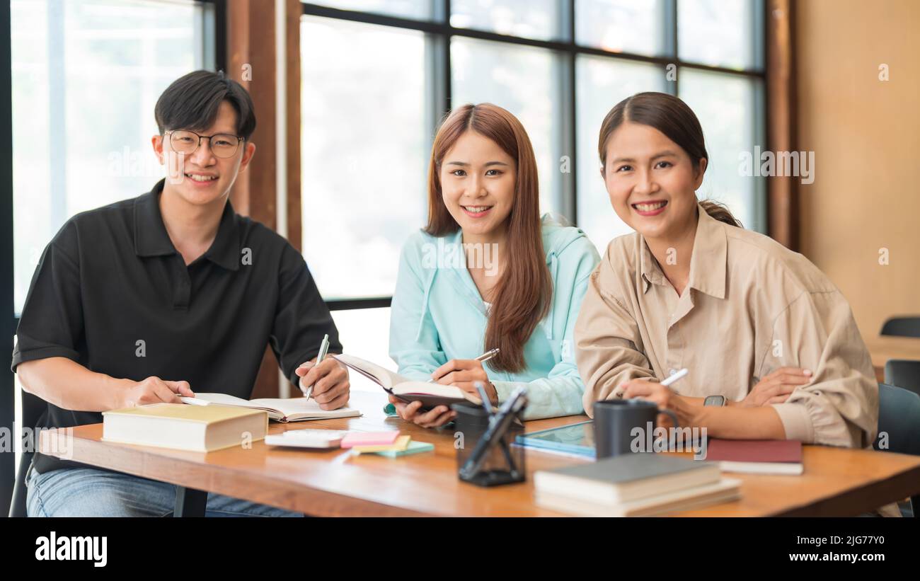 Education concept, Female tutor and students smiling and looking on ...