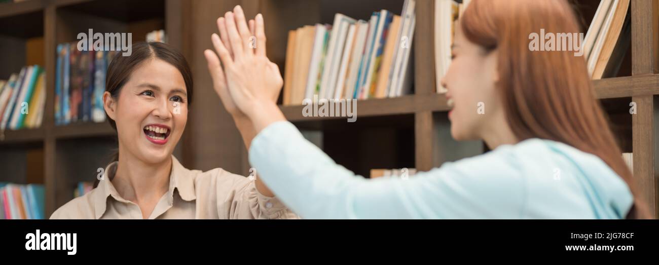 Education concept, Female tutor giving high five to celebrate with ...